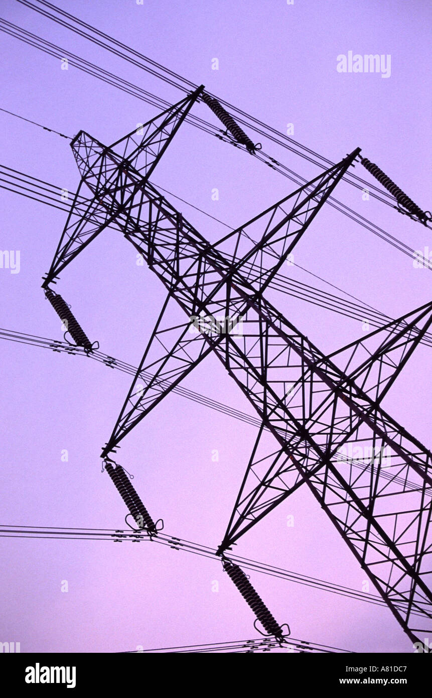 Electricity pylon silhouetted against a purple sky Stock Photo - Alamy
