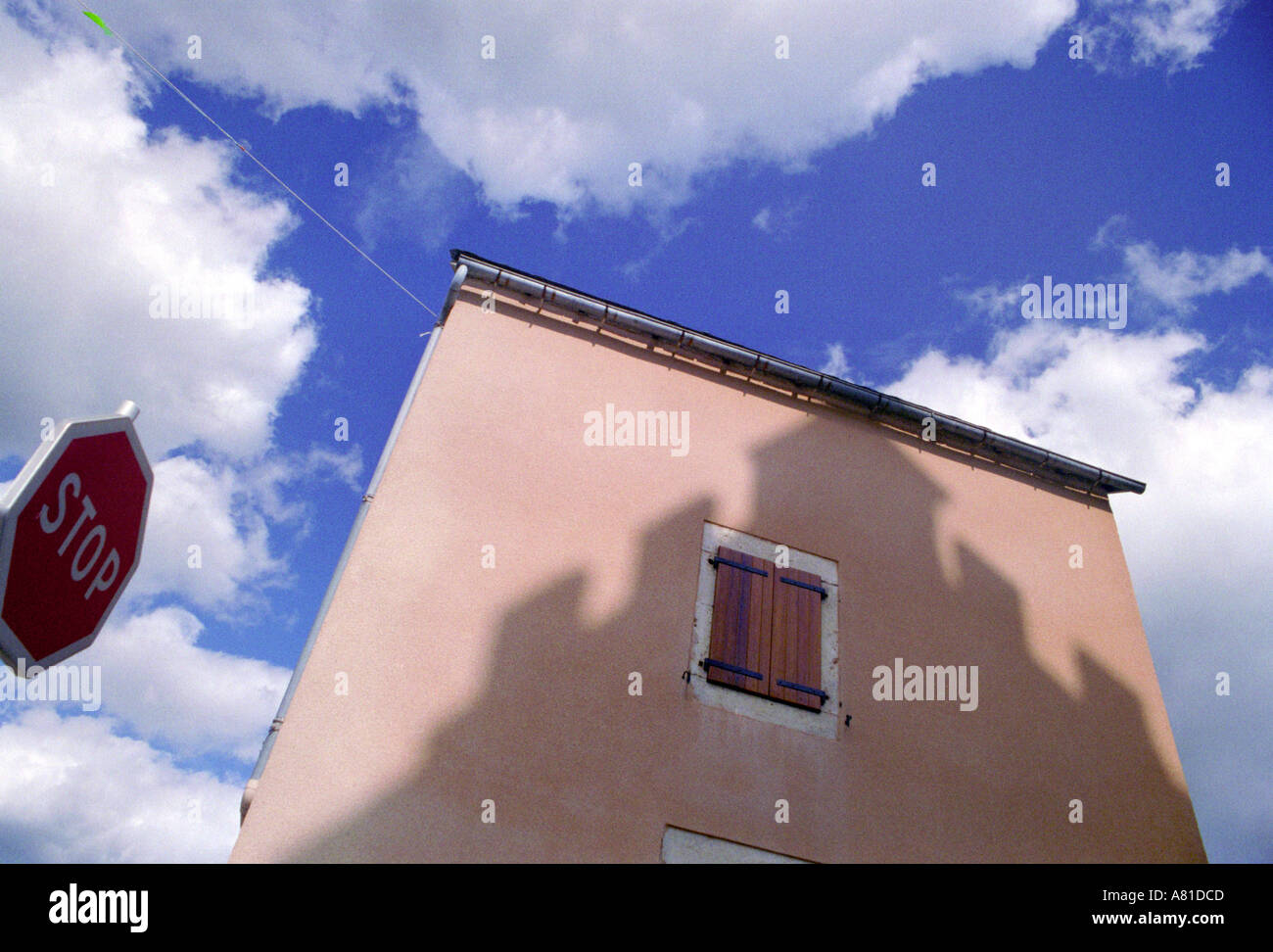 Stop sign on road with house behind Stock Photo - Alamy