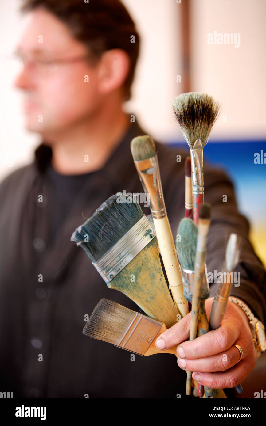 Artist holding artist's materials, paint brushes and pallette Stock ...