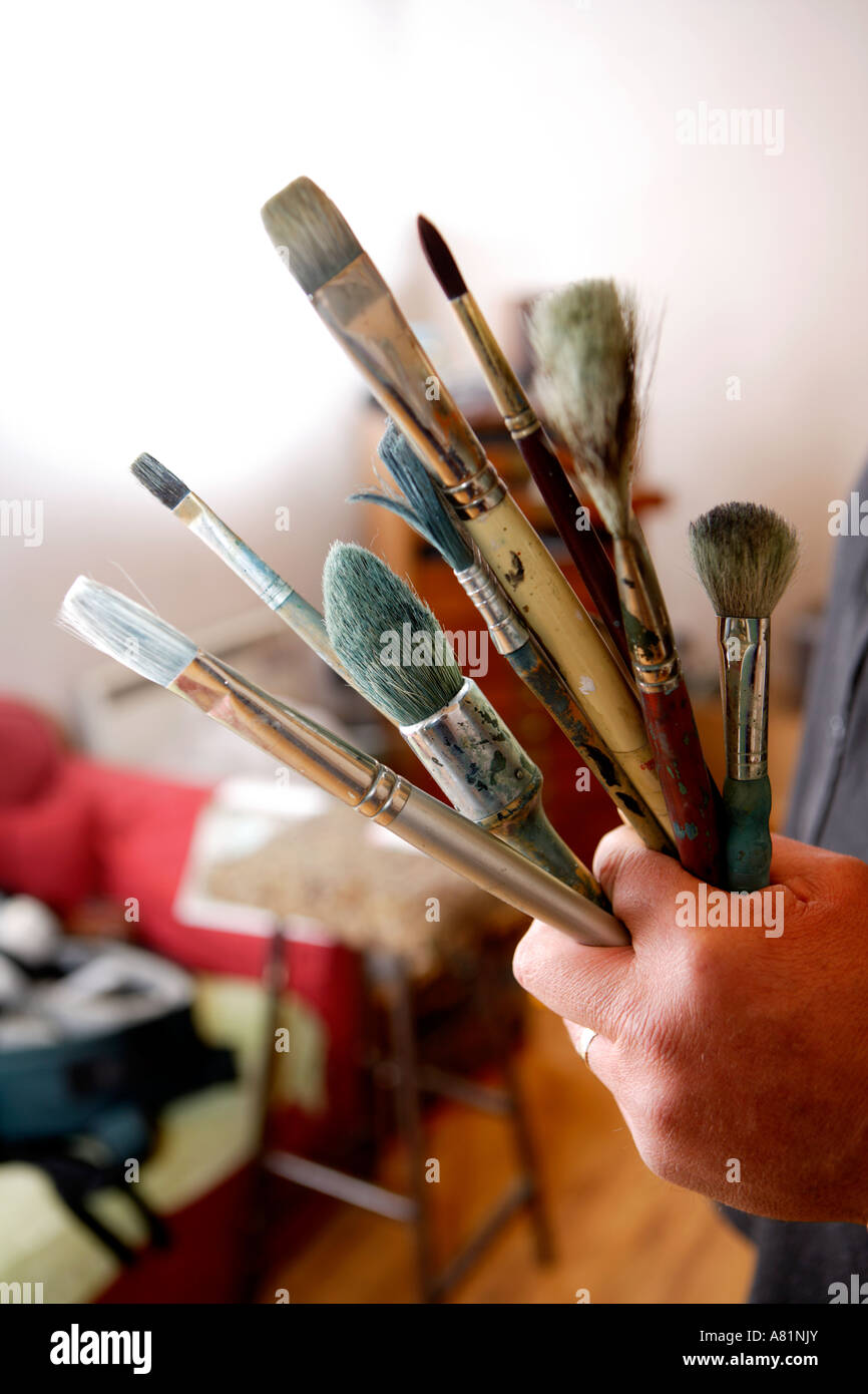 Artist holding artist's materials, paint brushes and pallette Stock ...