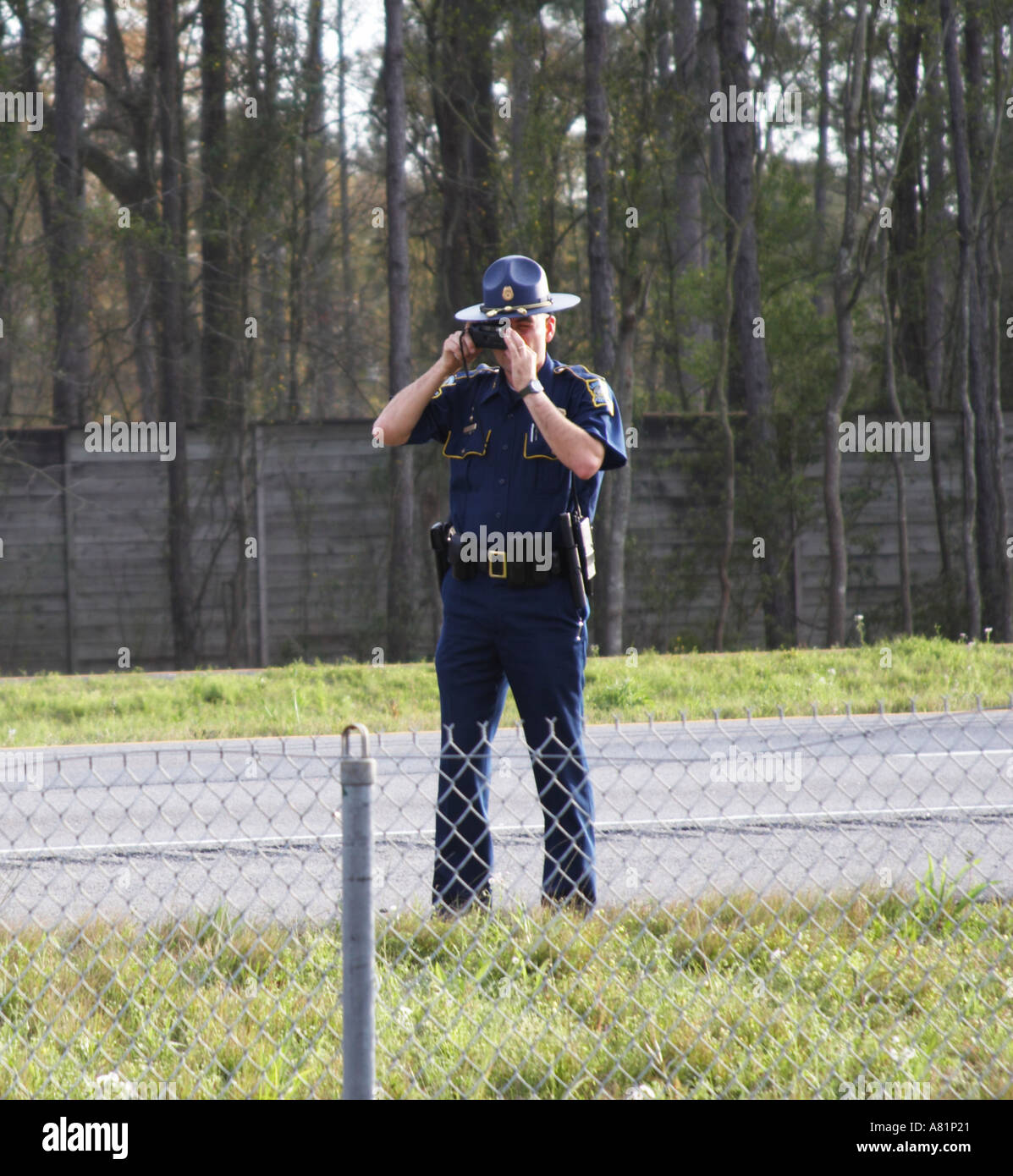 Louisiana State Police officer taking photographs at an accident scene ...