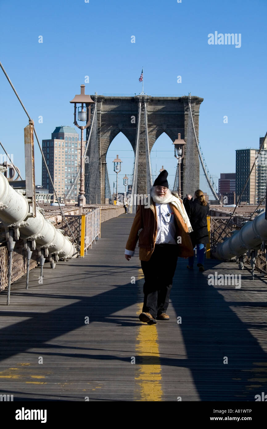 Large Man walking across the Brooklyn Bridge New York City Stock Photo ...