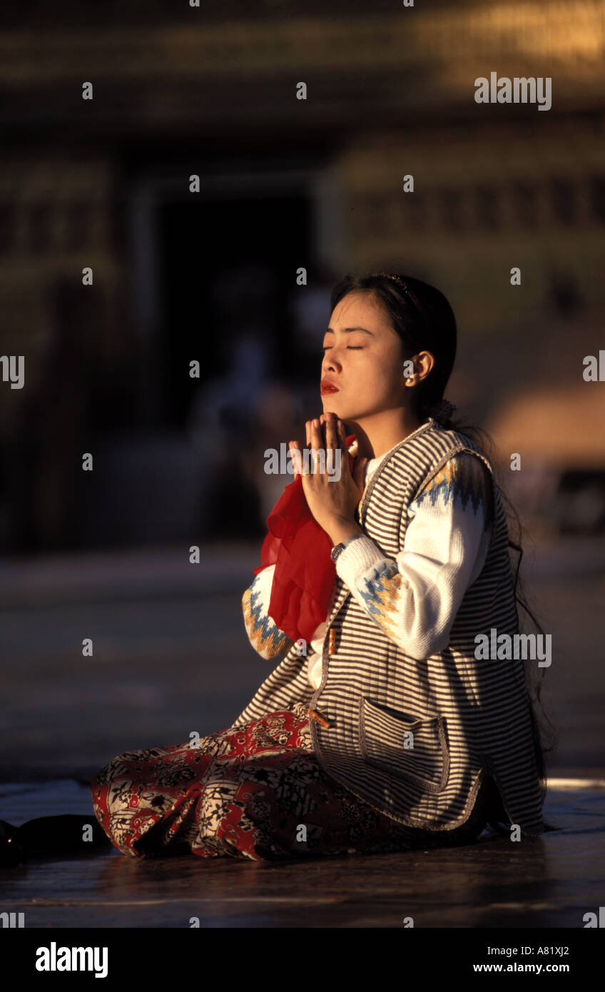 Myanmar (Burma), Mon state, woman praying in front of the golden rock ...