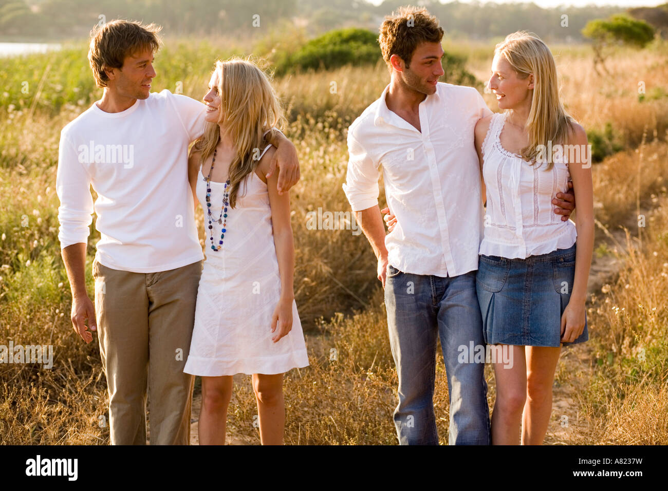 Two couples outdoors on a path Stock Photo - Alamy