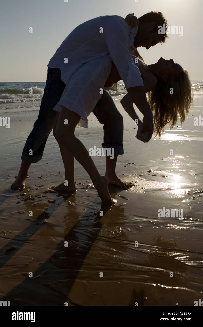 A couple at the beach dancing Stock Photo - Alamy