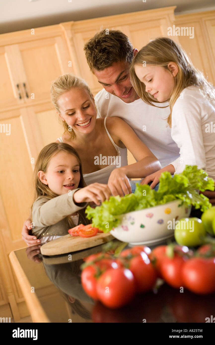 A family at home preparing a salad Stock Photo - Alamy