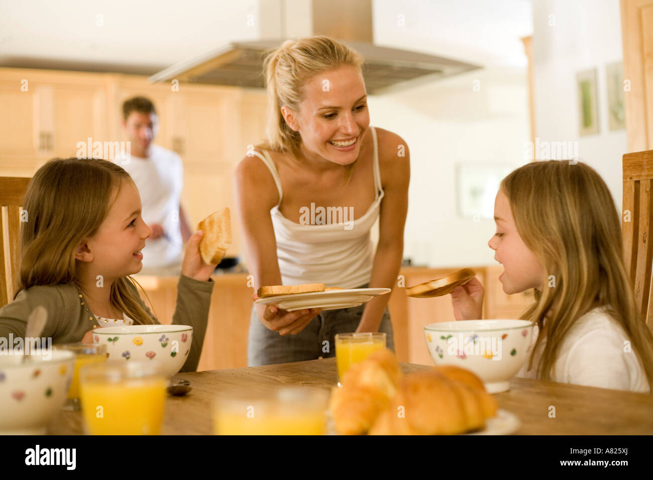 A family eating breakfast Stock Photo - Alamy