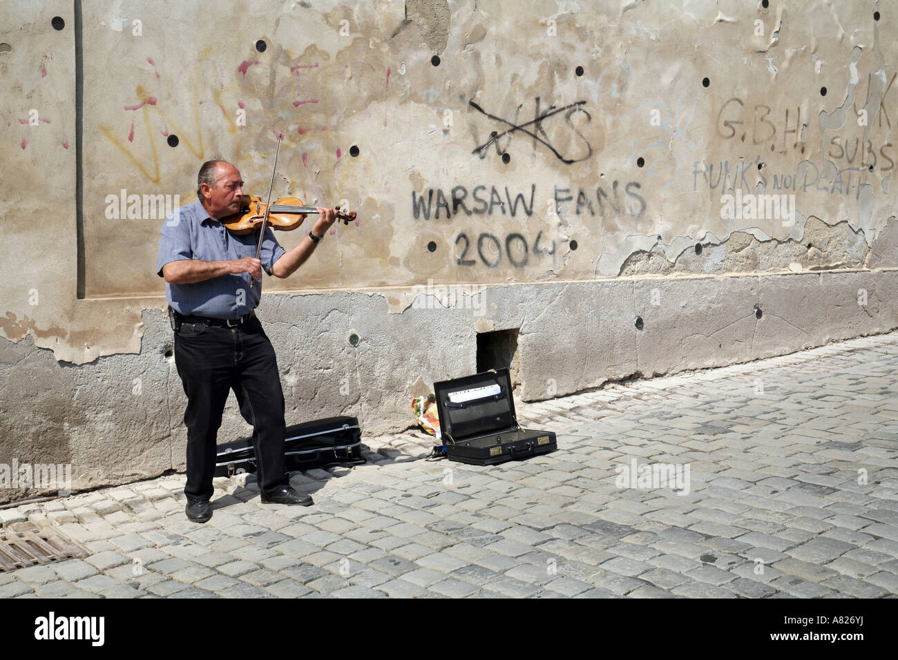 Prague busker; A violinist playing music on his violin by the roadside ...