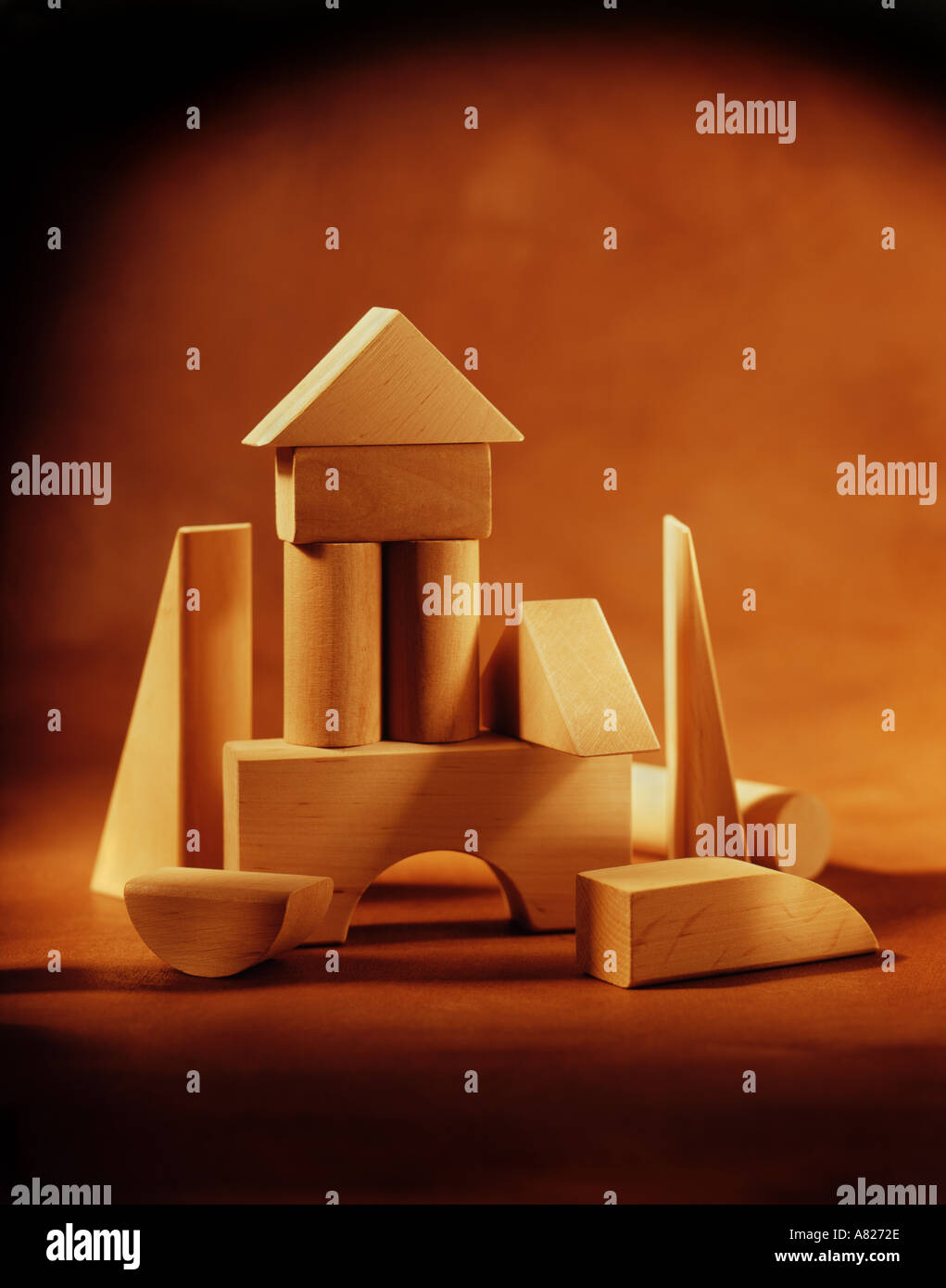 Still life of architectural playing blocks on a red brown background ...