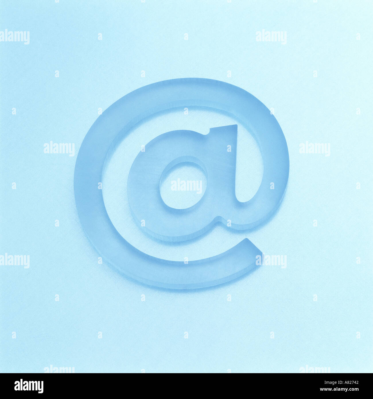 At Symbol on a Blue Background Stock Photo - Alamy