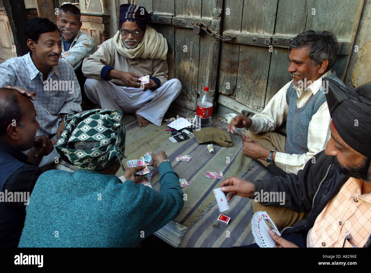 A group of Indian men play cards on the street in Delhi India Stock ...