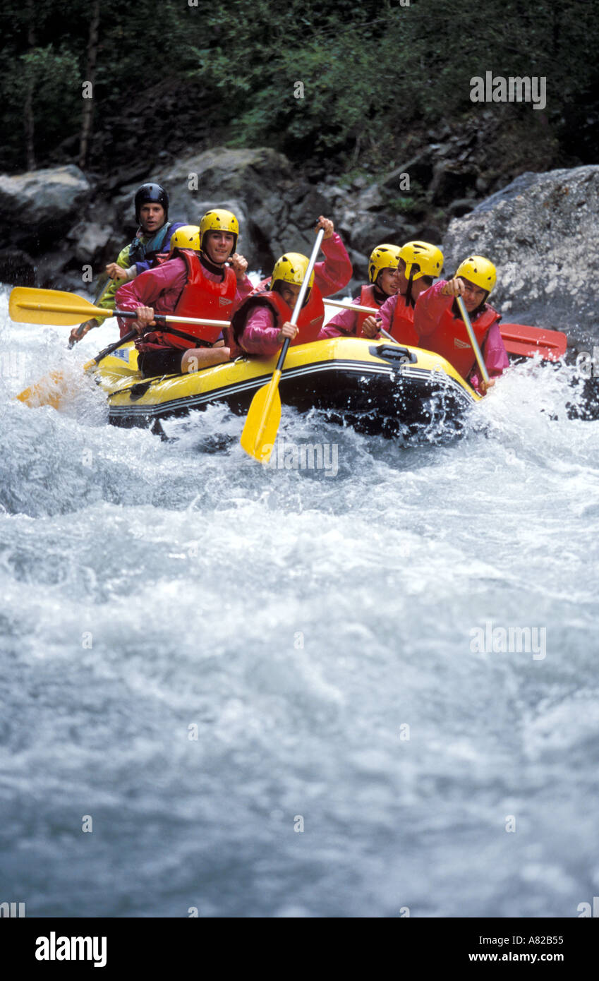 Young people white water rafting Stock Photo - Alamy