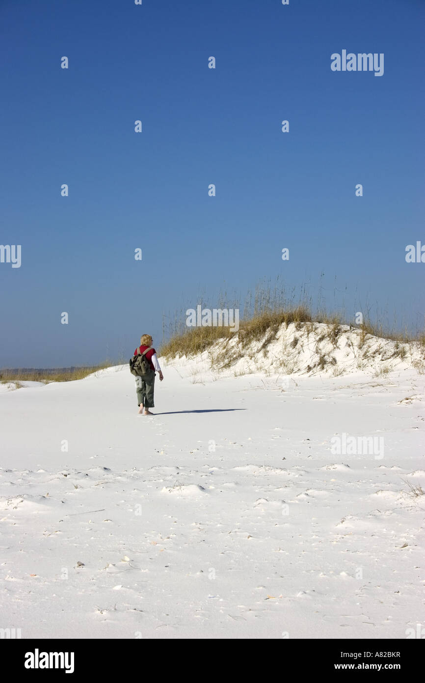 Woman walking the beach on Shell Island. Panama City Beach, Florida ...