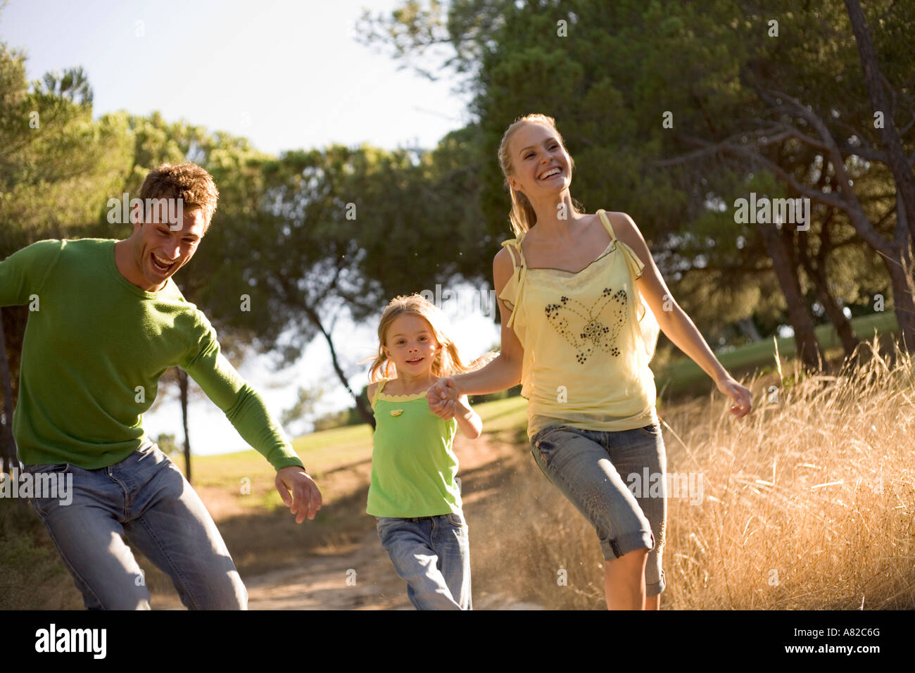 A family running on a path in a park Stock Photo - Alamy
