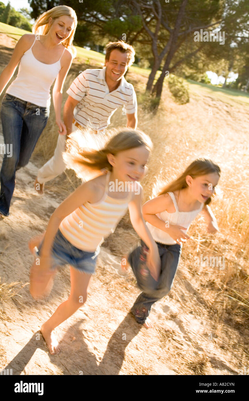 A family running down a path Stock Photo - Alamy