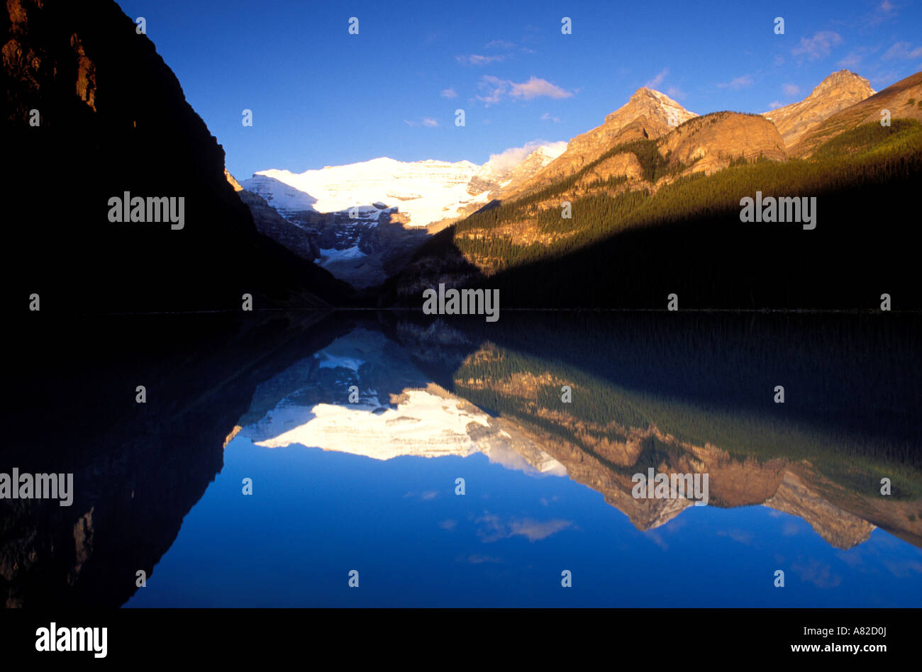 Dawn light on Mount Victoria reflected in Lake Louise Banff National ...
