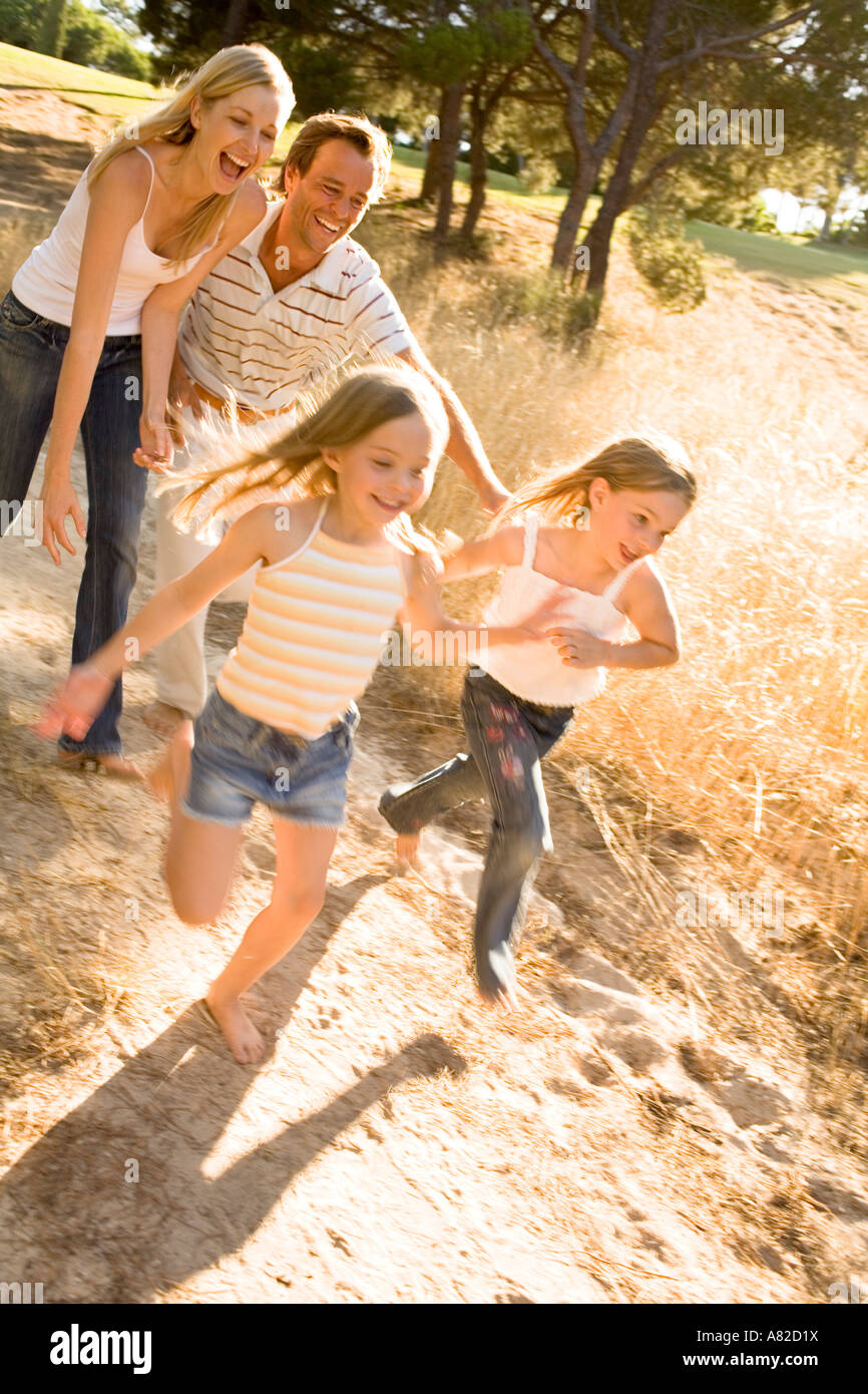 A family running down a path Stock Photo - Alamy