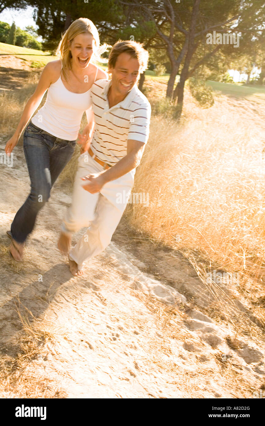 A couple running down a path Stock Photo - Alamy