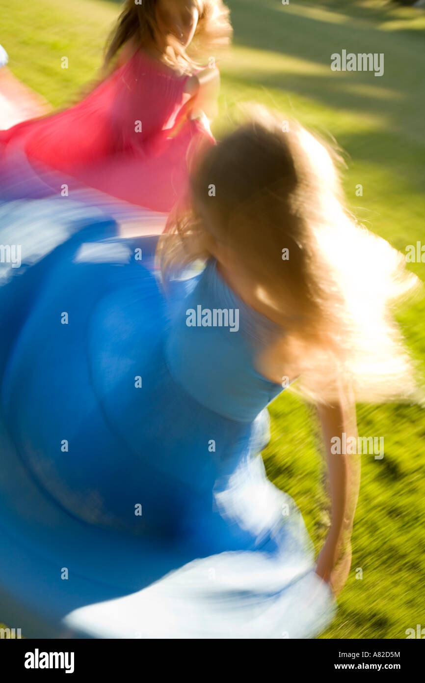 Two girls outdoors spinning Stock Photo - Alamy