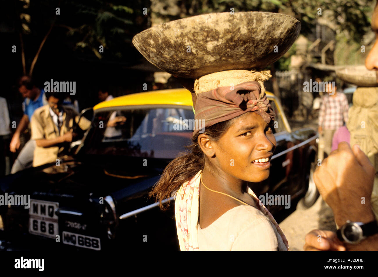 India, Maharashtra, Bombay (Mumbai), woman at work carrying stones ...