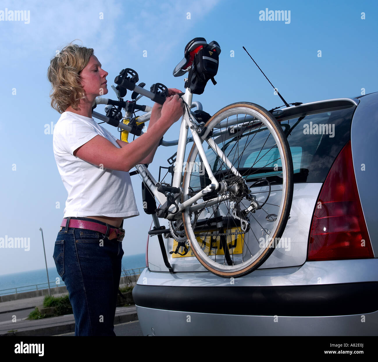 Lady loading her bike on to a Bike Rack Stock Photo - Alamy