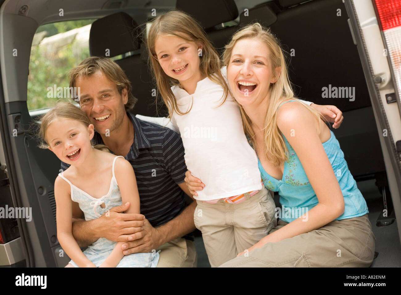 A family in the back of their van Stock Photo - Alamy