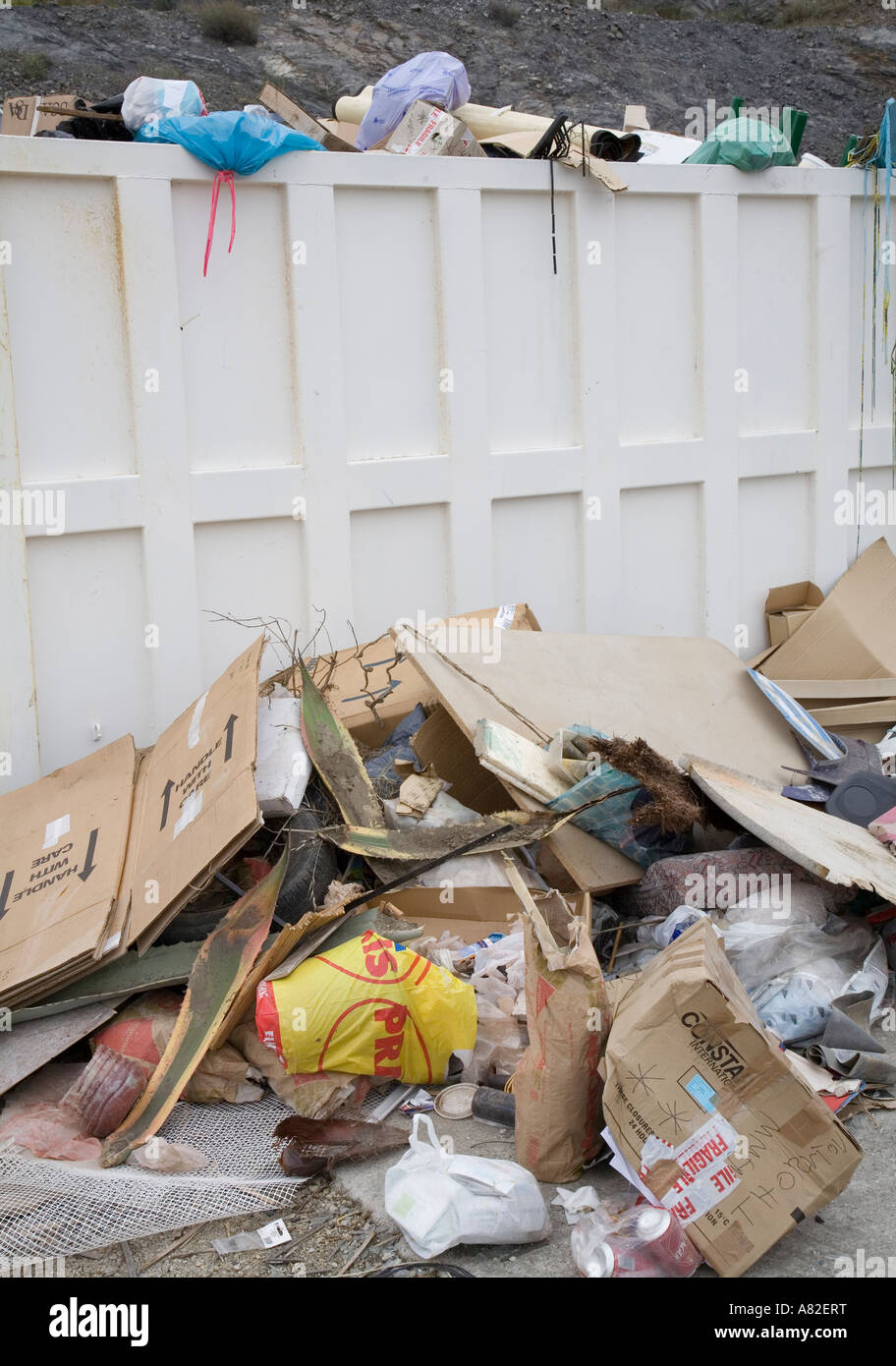 Untidy waste landfill thrown next to skip container Nerja Spain Stock ...