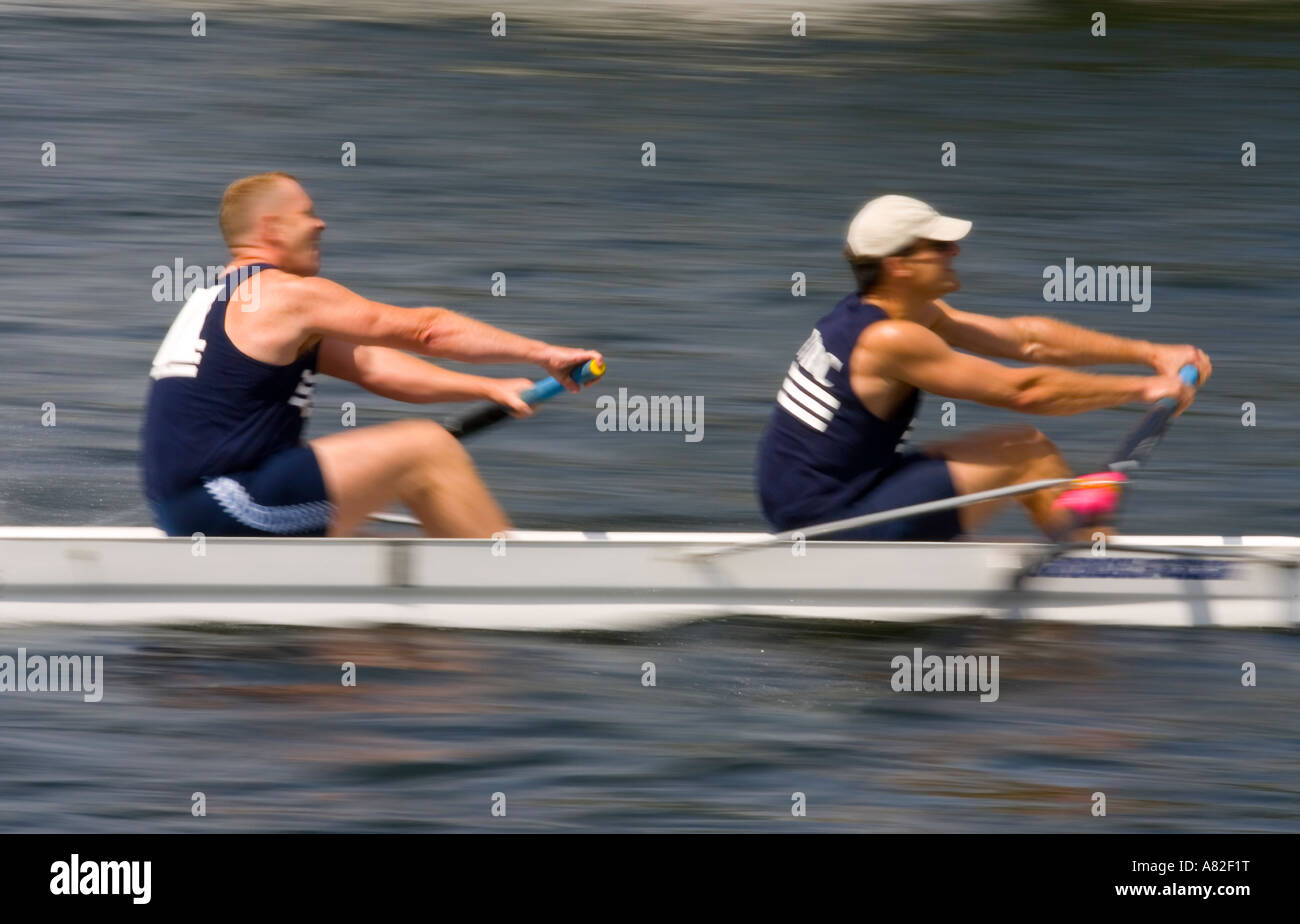 A motion blurred shot of a pair of rowers working hard to win a race ...