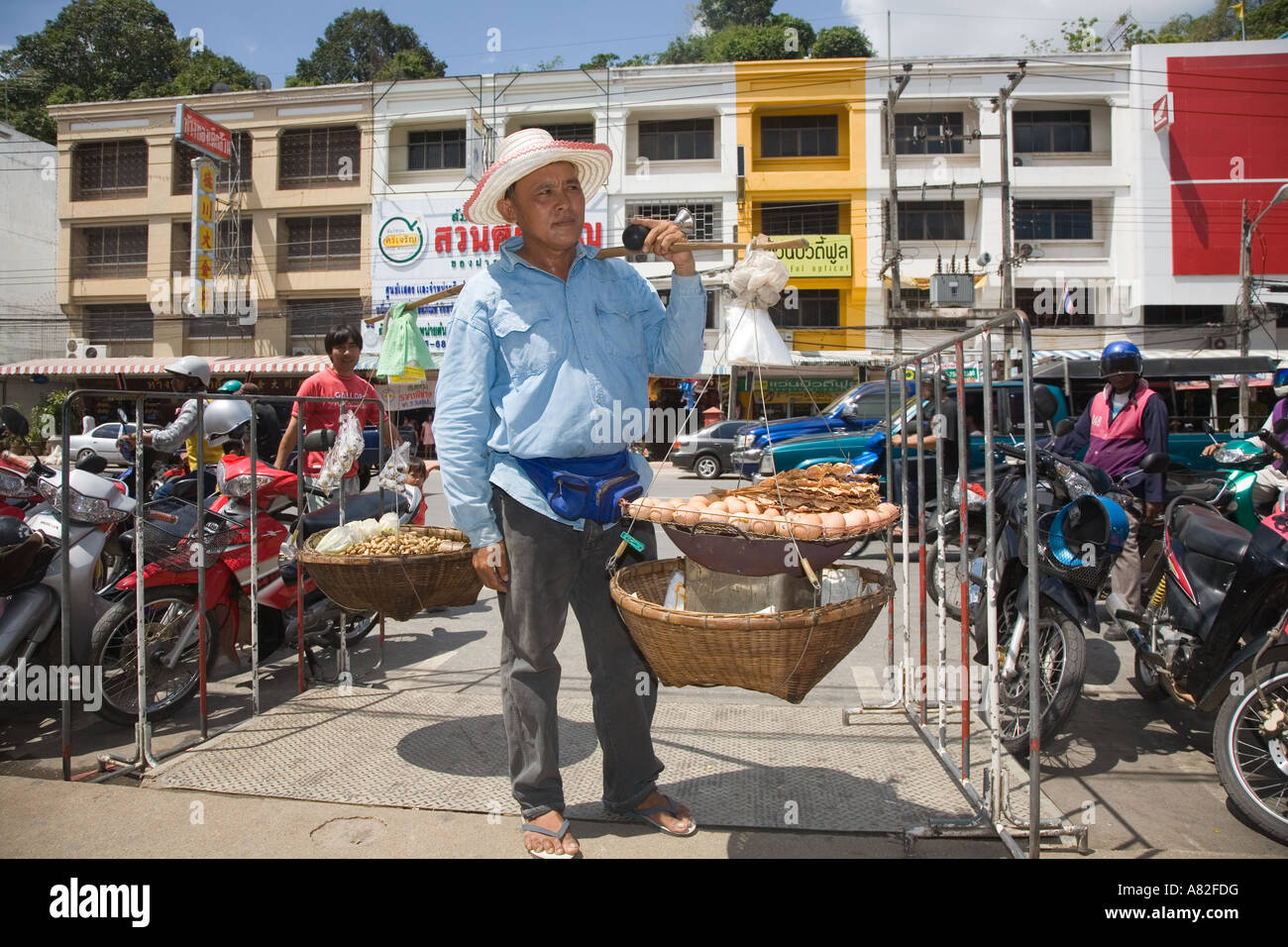 Egg Seller carrying a wood or bamboo yoke, street food in Krabi Town ...