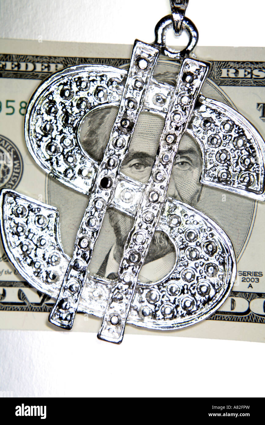 Dollar-sign jewelry on cash Stock Photo - Alamy
