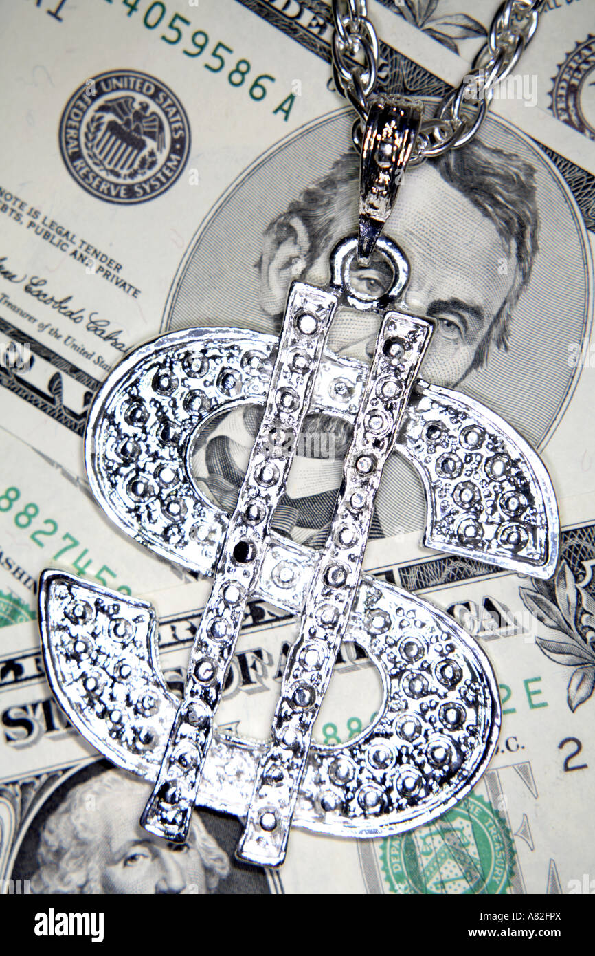 Dollar-sign jewelry on cash Stock Photo - Alamy