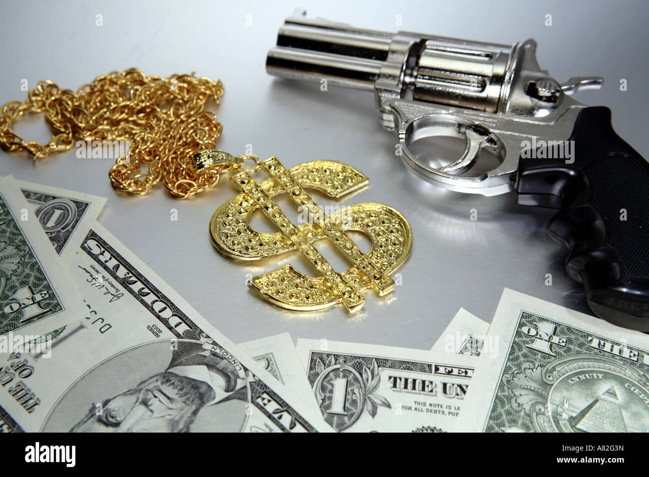 Money and gun Stock Photo - Alamy