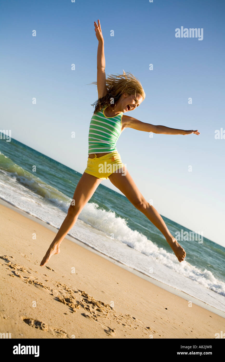 A woman jumping at the beach Stock Photo - Alamy