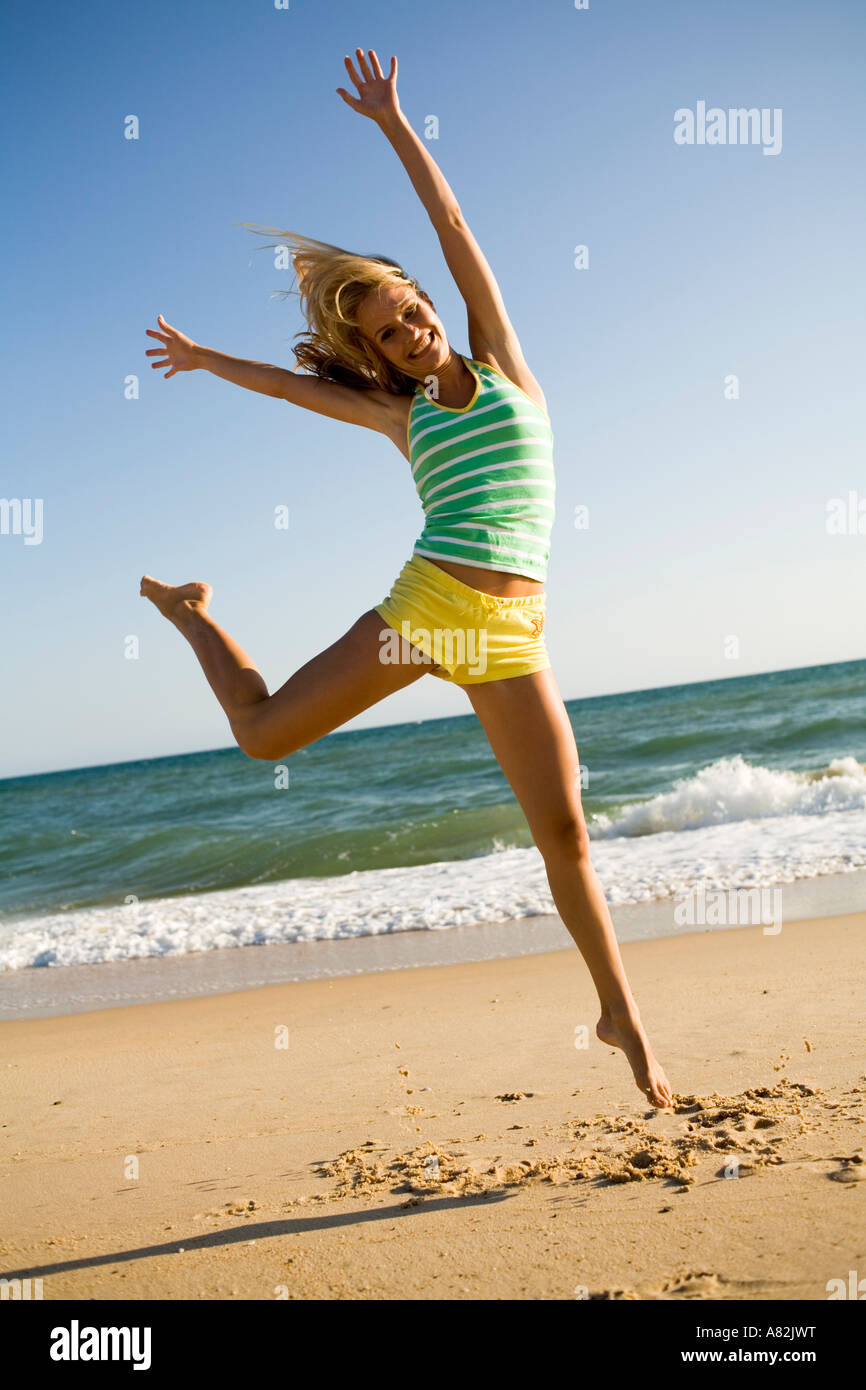 A woman jumping at the beach Stock Photo - Alamy