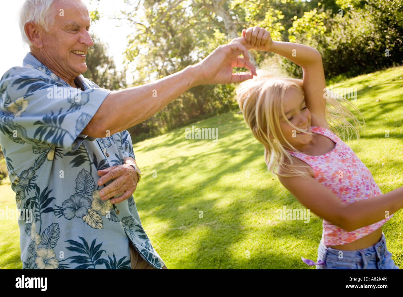 A grandfather with his granddaughter in a park dancing Stock Photo - Alamy