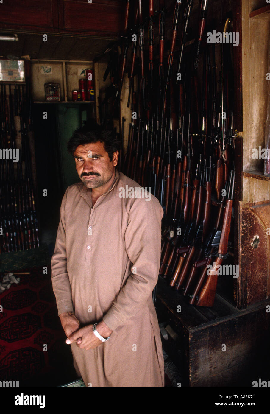 Pakistan NWFP Darra Adam Khel man in shop selling locally made guns ...
