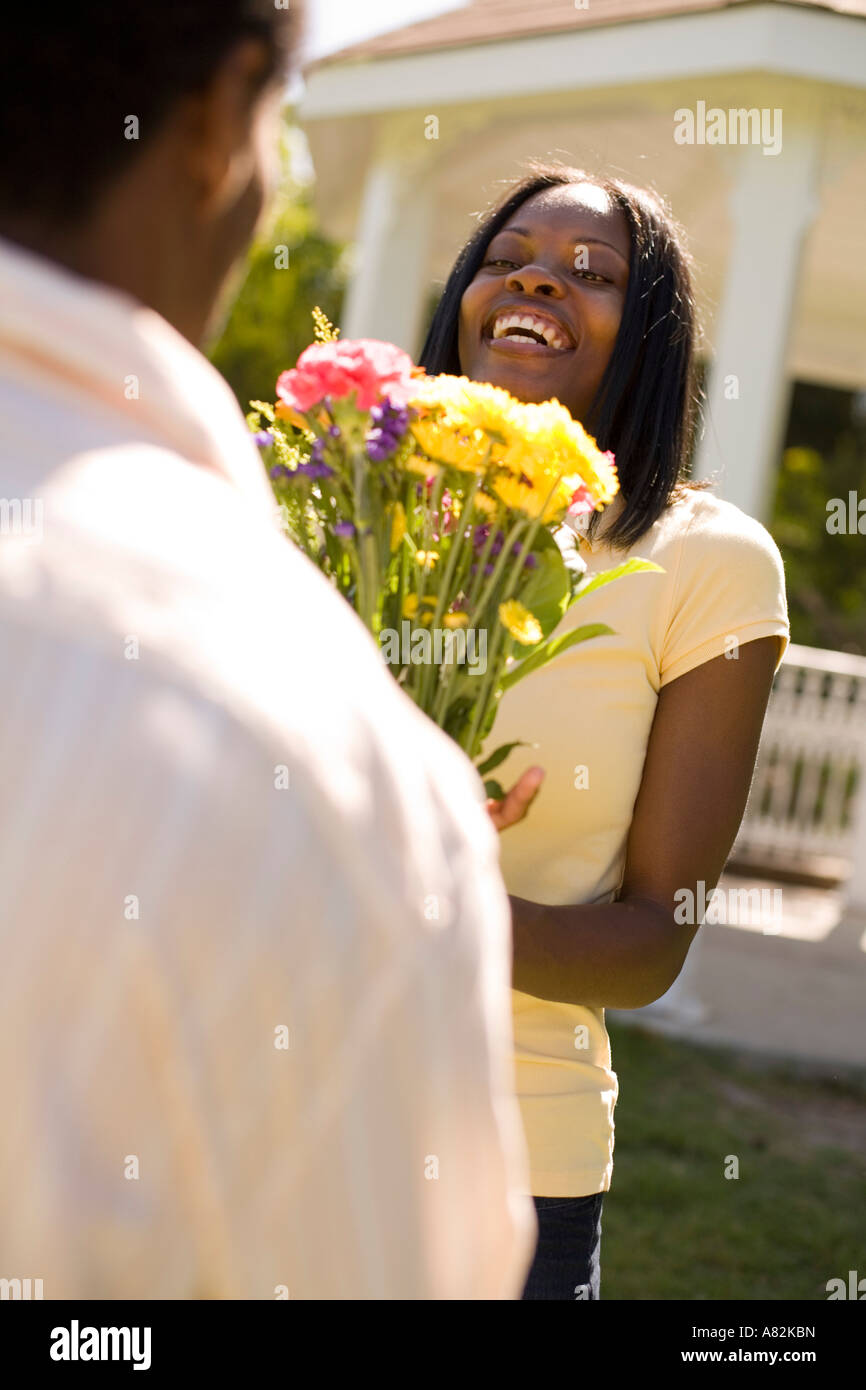A man giving a woman flowers Stock Photo - Alamy
