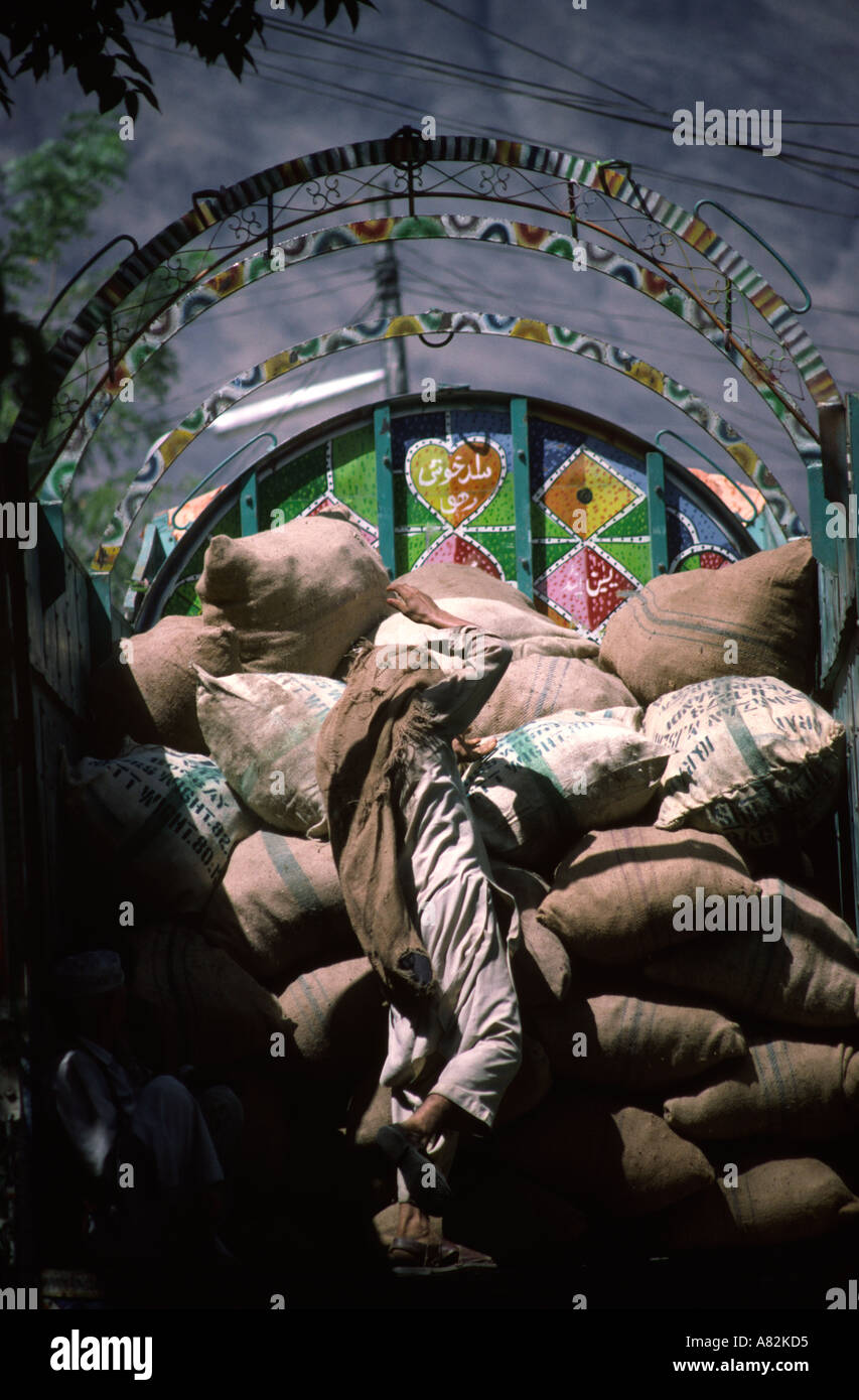 Pakistan Azad Kashmir Gilgit work labourer loading truck with sacks ...
