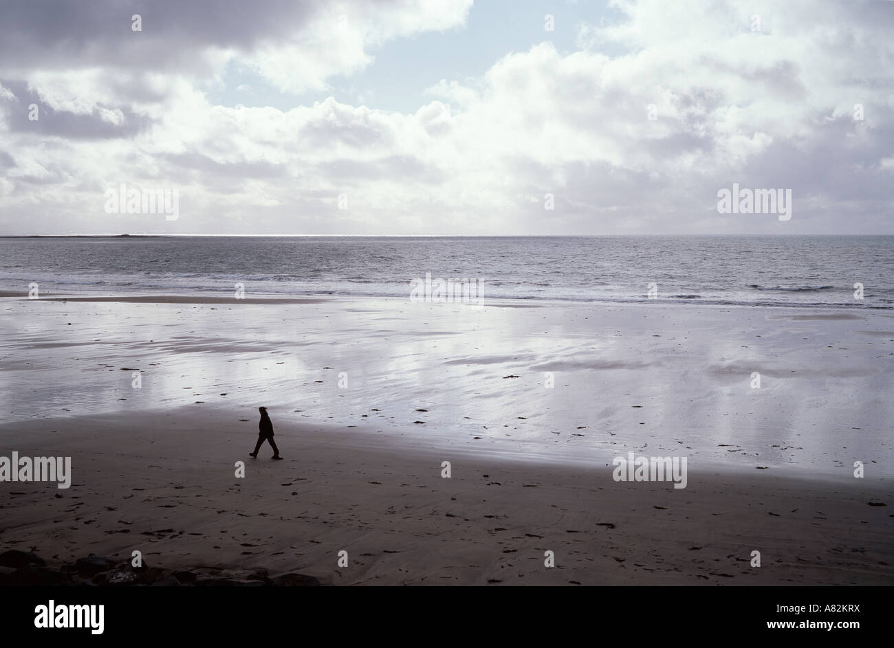 Woman walking on the beach in Akranes Iceland Stock Photo - Alamy