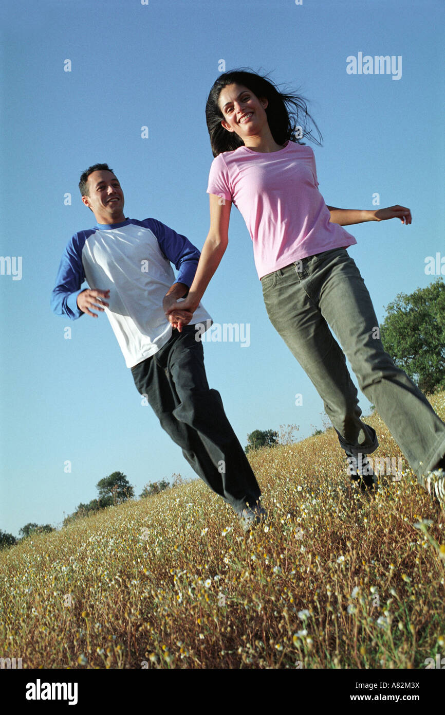 A couple running outdoors Stock Photo - Alamy