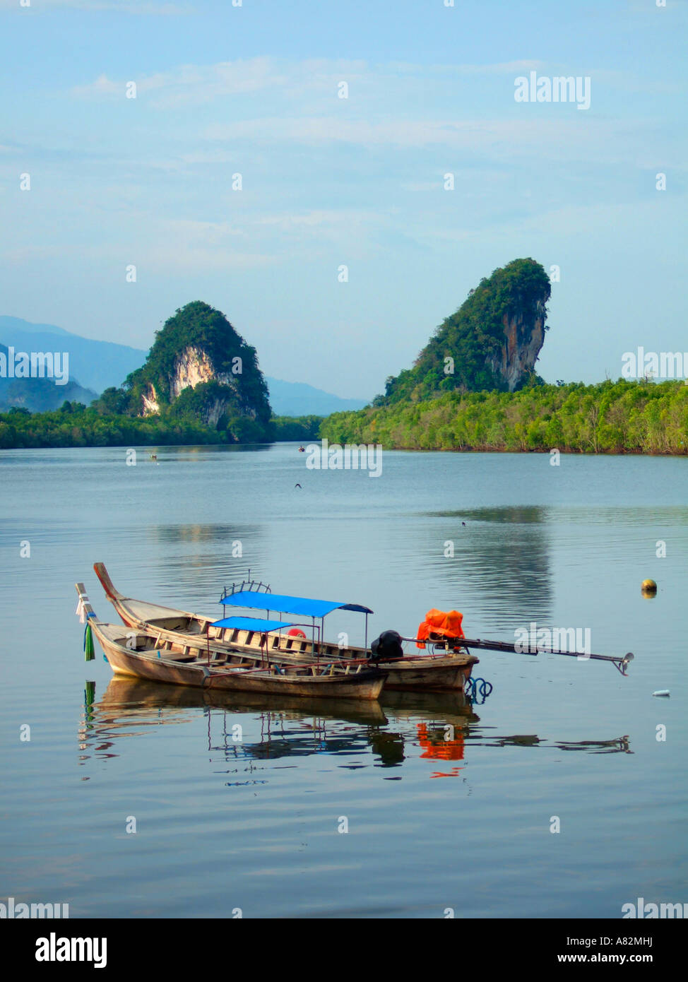 Longtail boats with limestone rock scenery in background Krabi Thailand ...