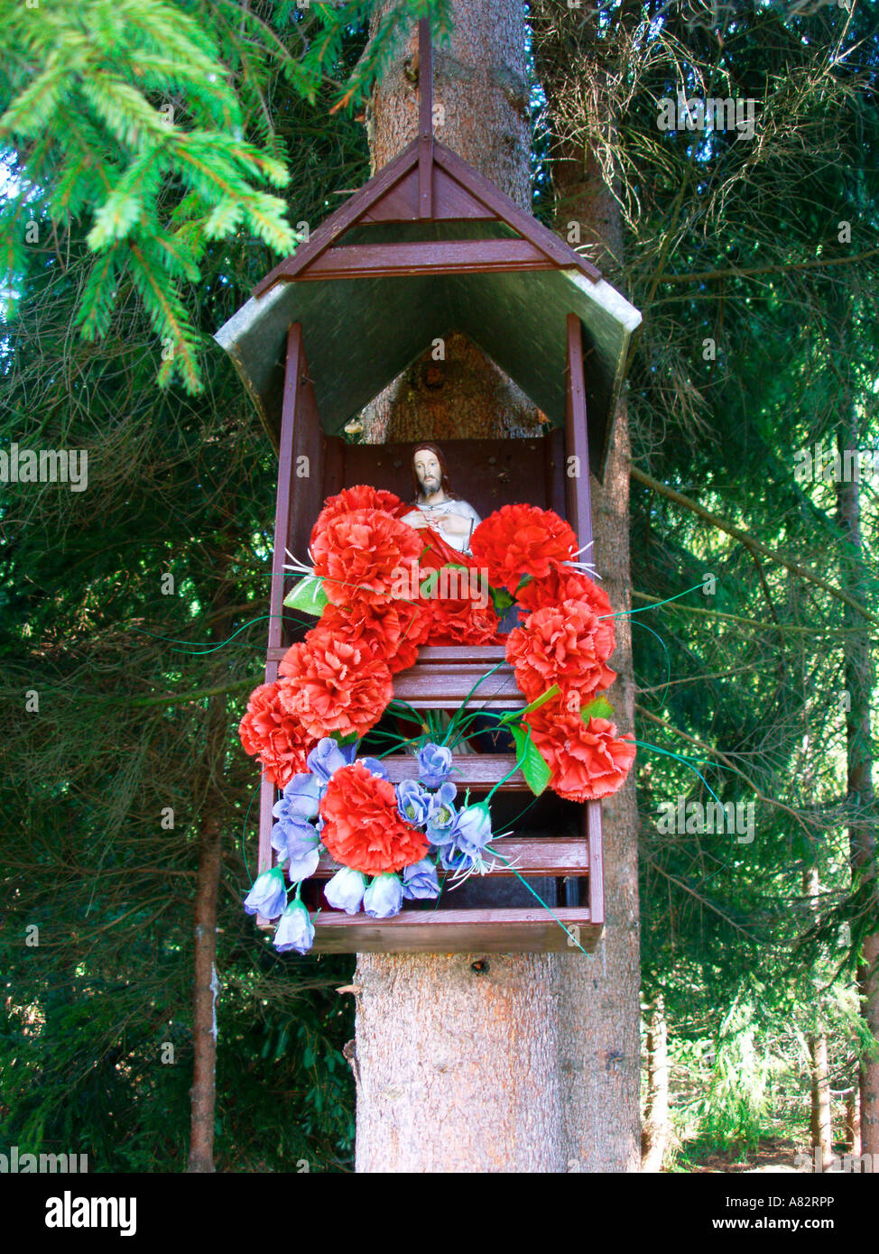 Small chapel shrine on tree Stock Photo - Alamy