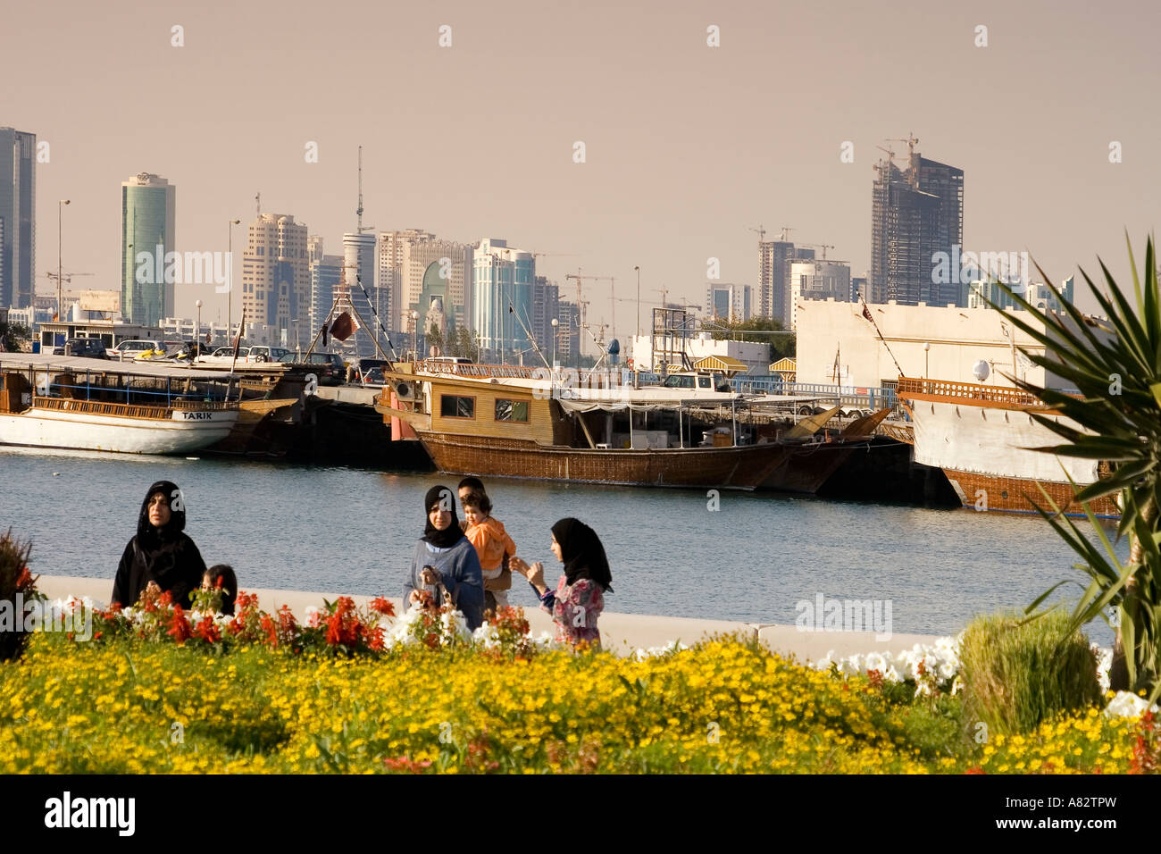 Qatar Doha bay skyline promenade veiled arabian women Stock Photo - Alamy