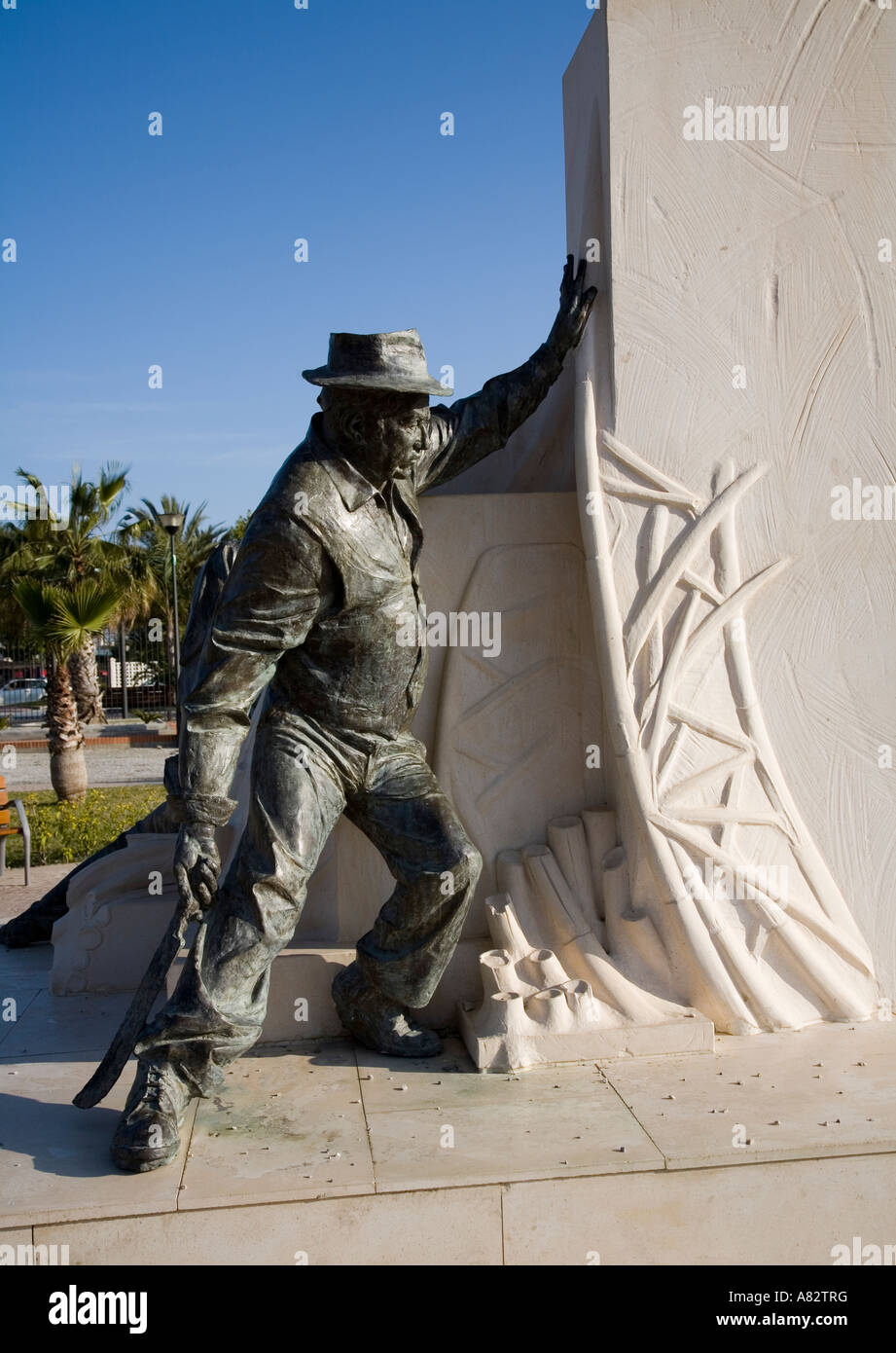 Statue of sugar cane farmer havesting crop Salobrena beach area Costa ...