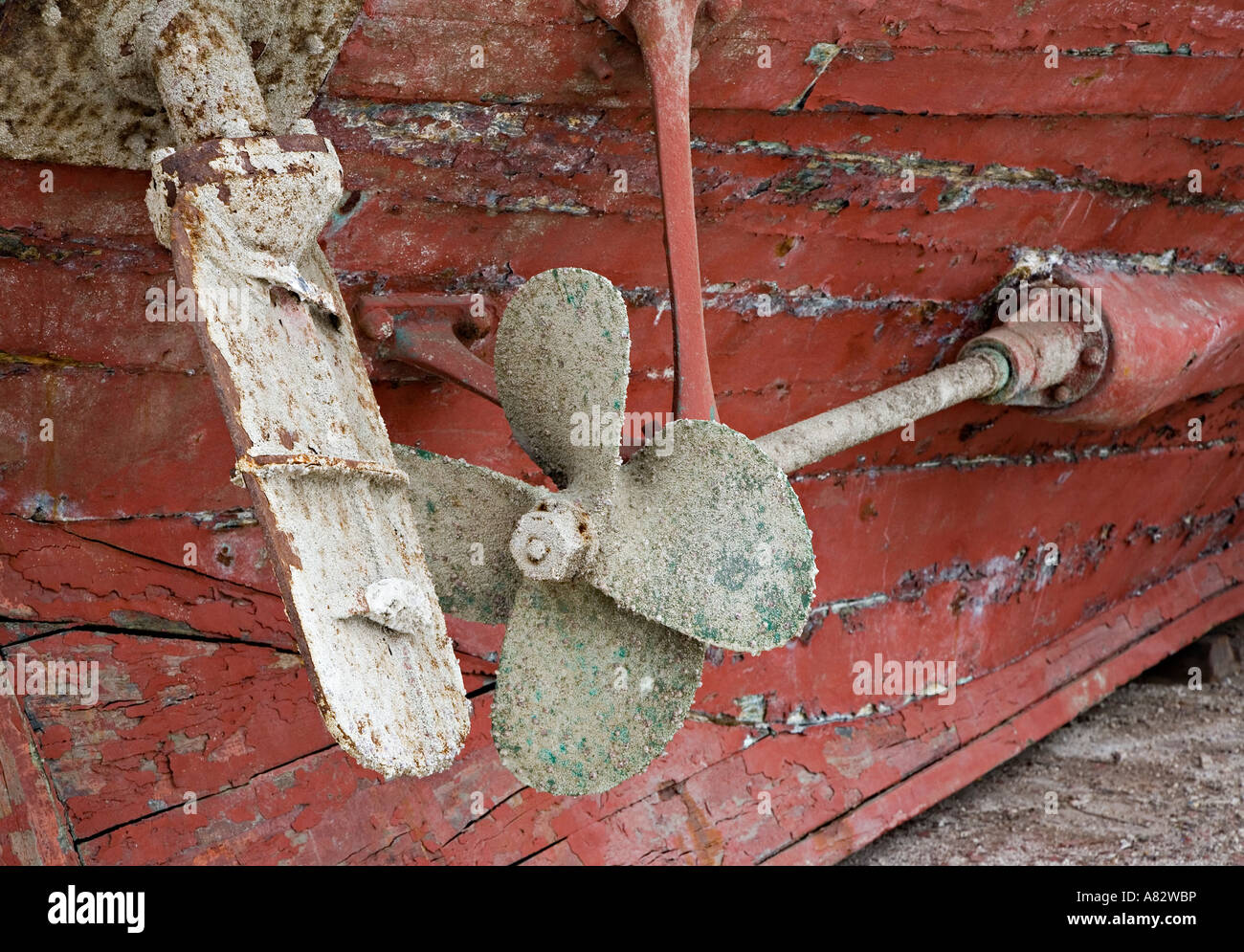 Boat hull in dry dock with propeller covered in barnacles needing ...