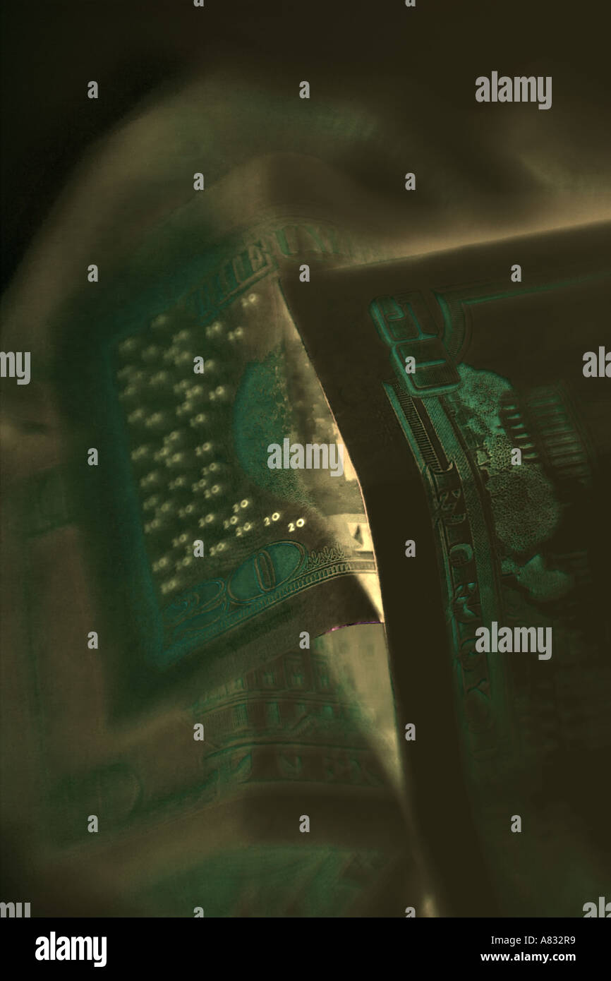 Various denominations of American dollar bills in a pile with dim ...