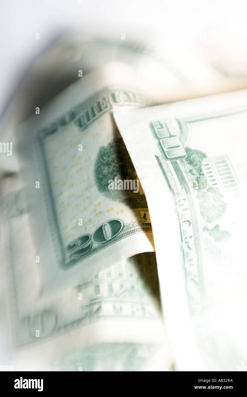 A variety of American Bill denominations in a pile with white glow ...