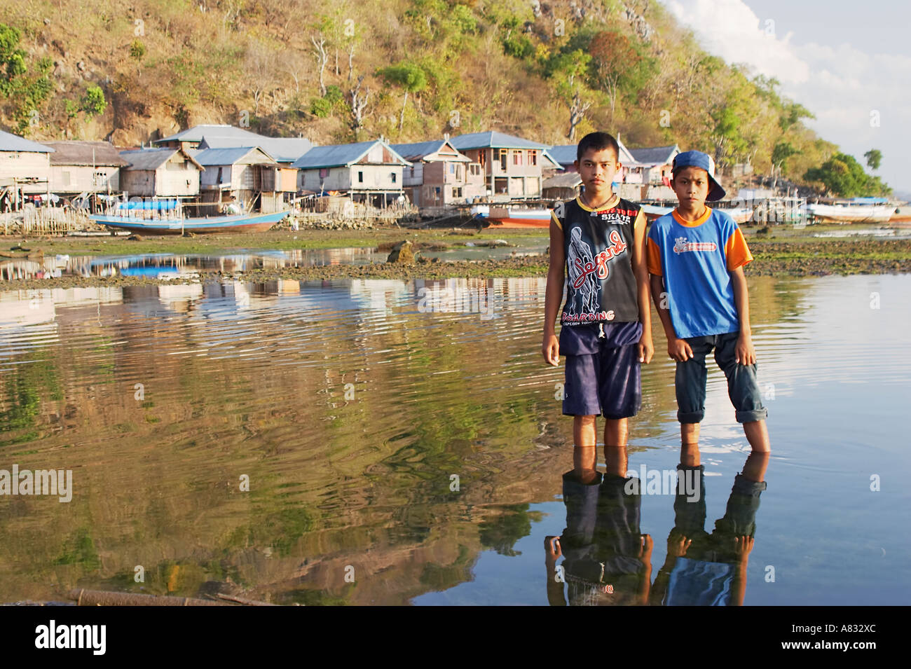 Two boys standing in sea hi-res stock photography and images - Alamy