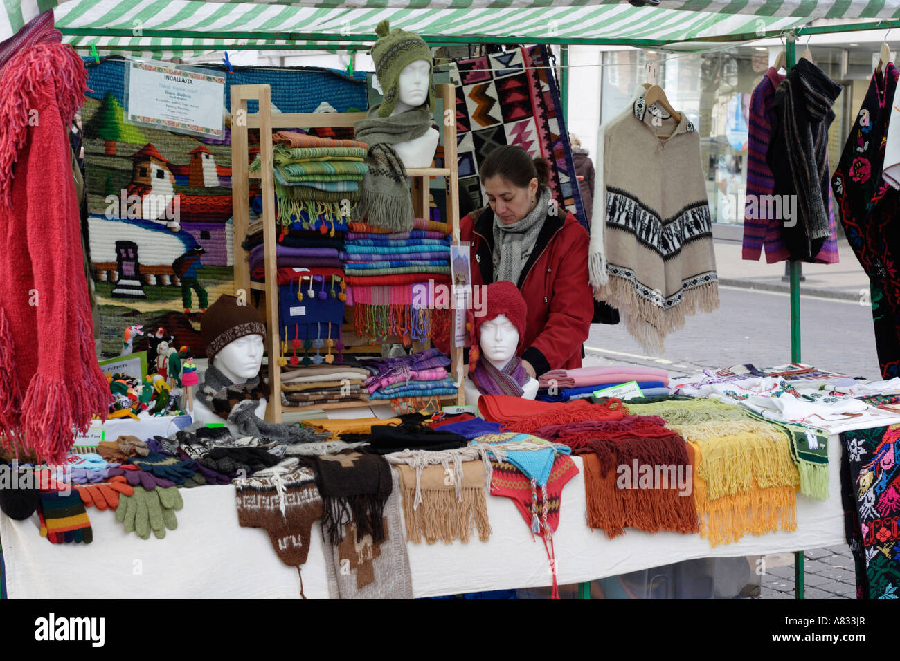 Stallholder with her display of hand woven clothes at a fair trade ...