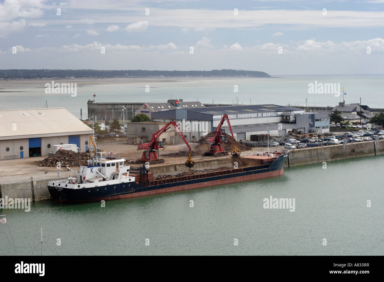 Cargo ship being loaded with scrap metal by grab cranes, Granville ...